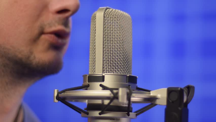 man speaking into studio microphone mid Stock Footage Video (100% ...