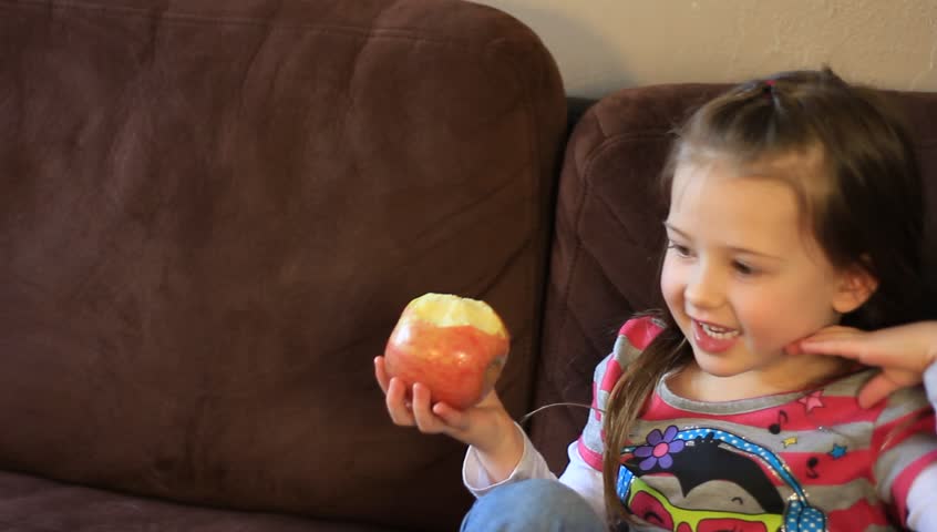 little girl eating apple talking Stock Footage Video (100% Royalty-free ...
