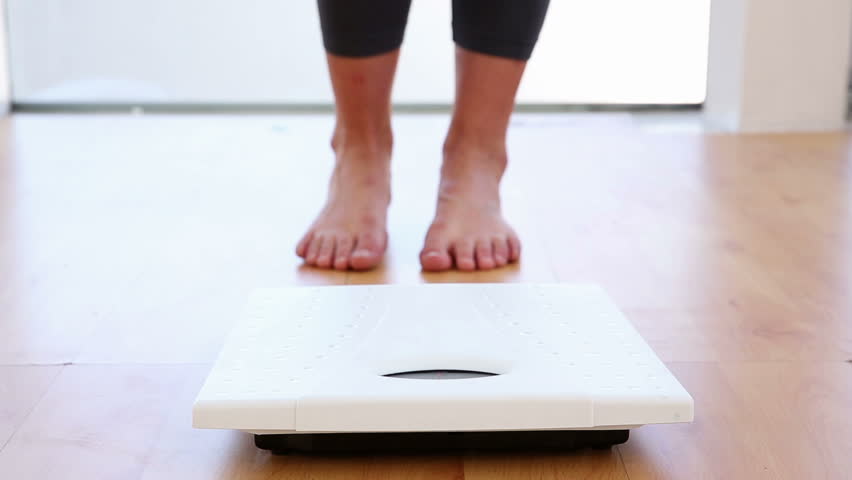Woman Stepping On Scales at Stock Footage Video (100% Royalty-free ...