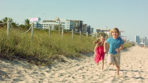 Two Little Kids Run Down Beach Stockvideoklipp (helt royaltyfria ...