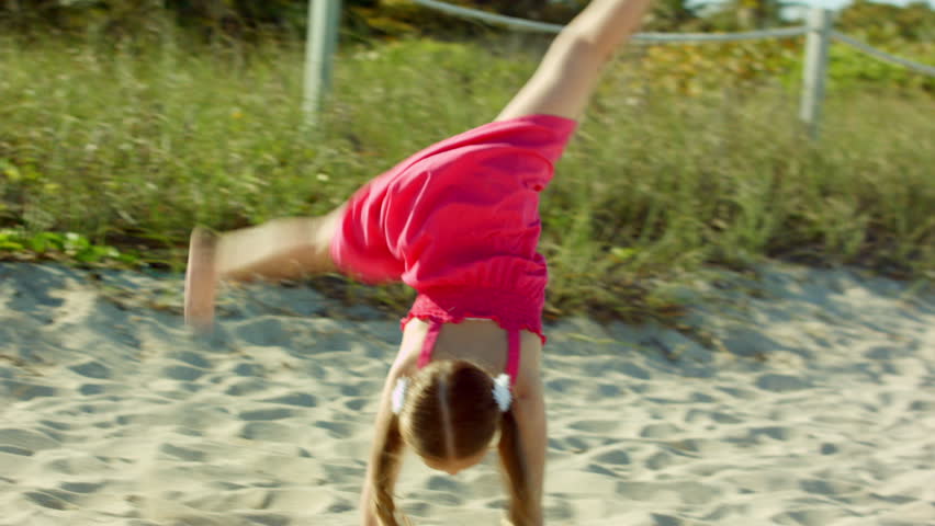 little girl practices cartwheels on beach Stock Footage Video (100% ...