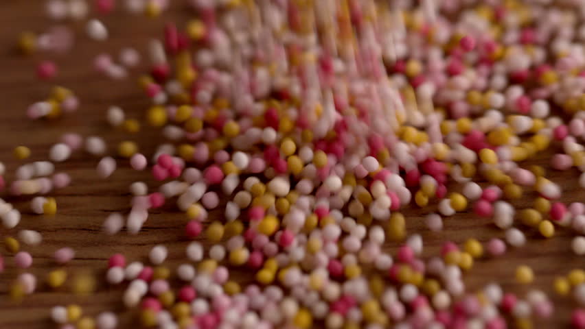 colourful sprinkles pouring onto surface slow 스톡 동영상 비디오(100% 로열티 프리 ...