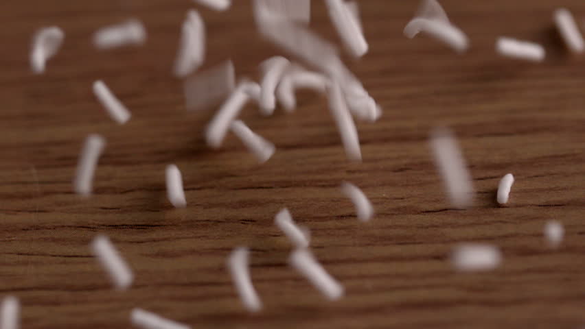 White Sprinkles Pouring Onto Surface Stock Footage Video (100% Royalty ...
