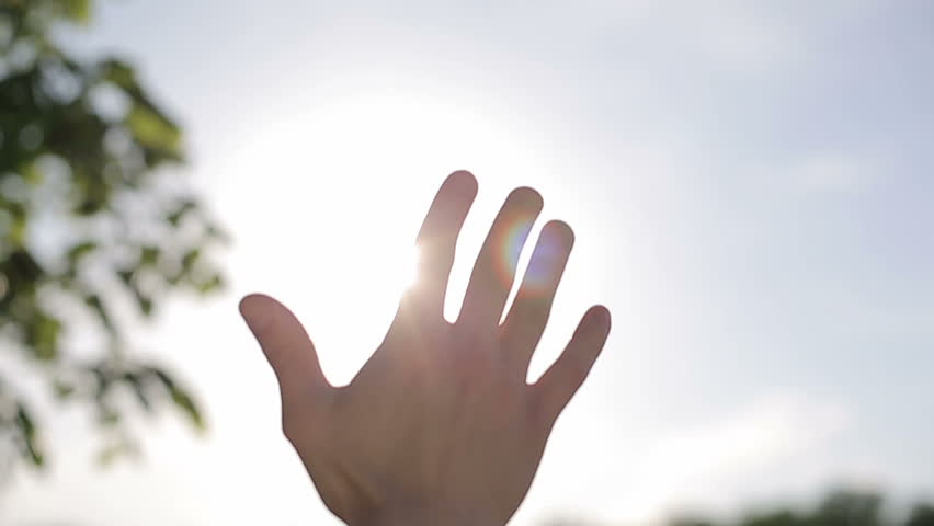 sun's rays through fingers male hand Stock Footage Video (100% Royalty ...