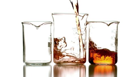 Orange Liquid Pouring Into Three Beakers Stock Footage Video (100% ...