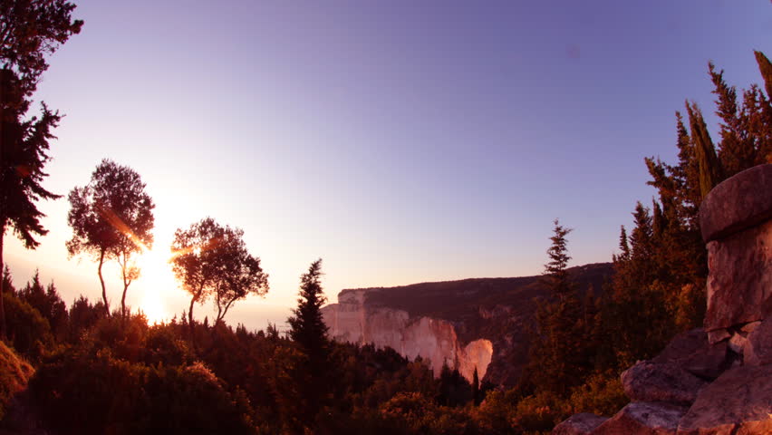 sunset over cliff silhouetted trees Stock Footage Video (100% Royalty ...