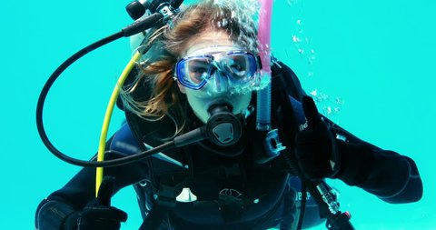 female scuba diver playing regulator underwater Stock Footage Video ...