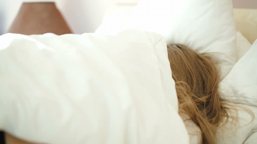 sleepy woman rolling over bed appearing Stock Footage Video (100% ...