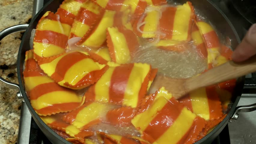 lobster striped ravioli being stirren boiling Stock Footage Video (100% ...