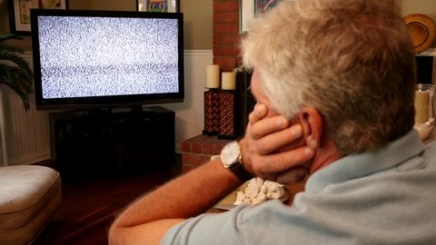 Man Sits Frustrated Watching Static On Stock Footage Video (100% ...