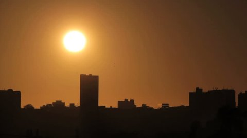 time lapse sun rising behind downtown Stock Footage Video (100% Royalty ...