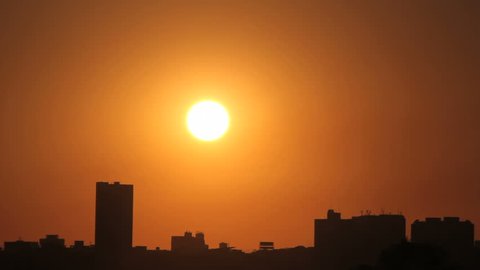 time lapse sun rising behind downtown Stock Footage Video (100% Royalty ...