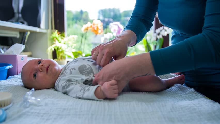 mother changing her baby's clothes Stock Footage Video (100% Royalty ...