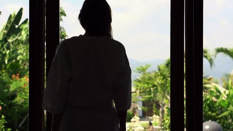 man looking out window watching heavy Stock Footage Video (100% Royalty ...