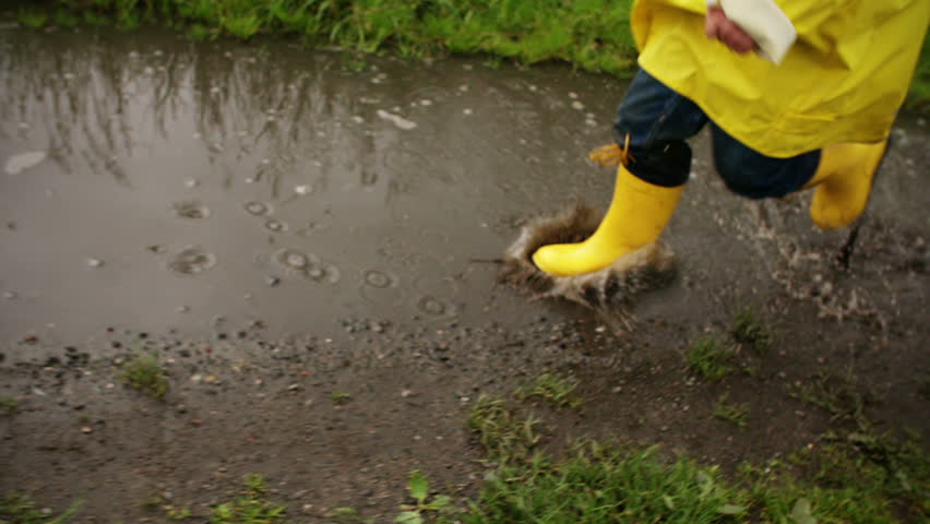 Young Boy Running Through Puddle Stock Footage Video (100% Royalty-free ...