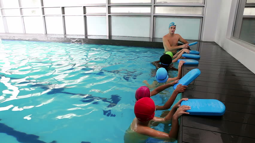 swimming coach teaching children how swim Stock Footage Video (100% ...