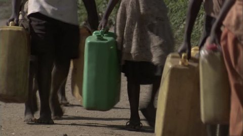Villagers Carrying Jerry Cans Down Road Stock Footage Video (100% ...