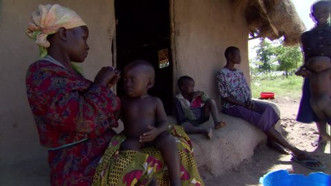 Kenyan Women Bathe Children Outside Hut Stock Footage Video (100% ...