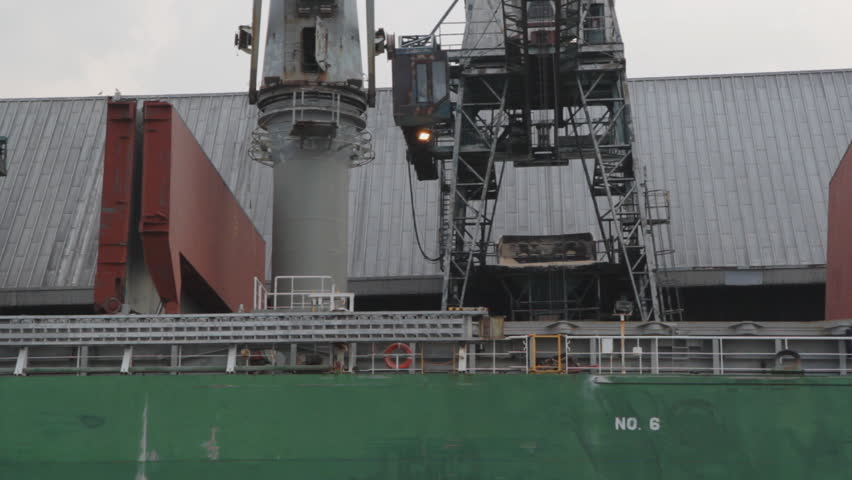 unloading cargo ship crane bucket unloads Stock Footage Video (100% ...
