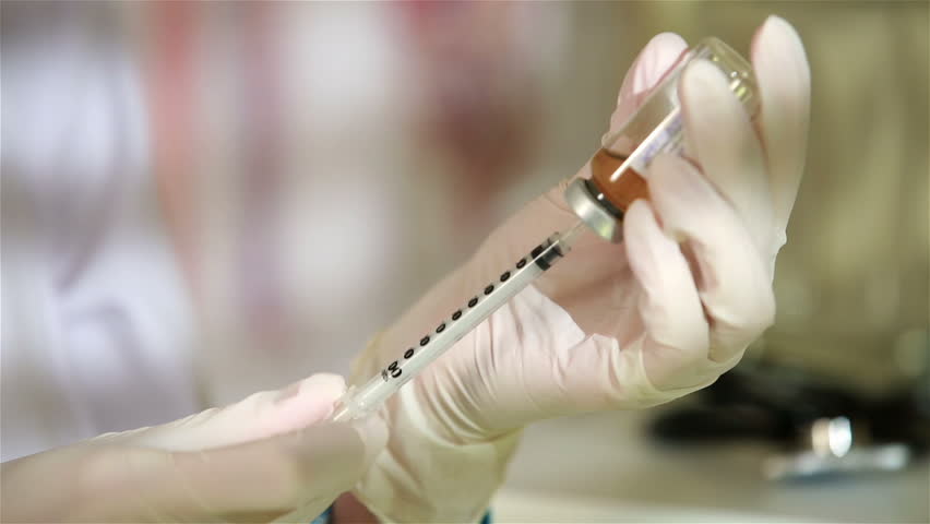 female doctor picking medication into syringe Stock Footage Video (100% ...