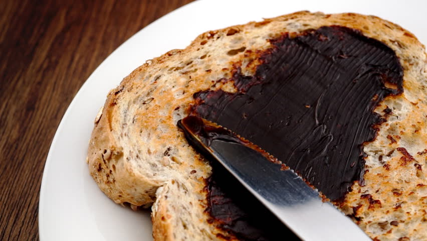 spreading australian vegemite on whole wheat Stock Footage Video (100% ...