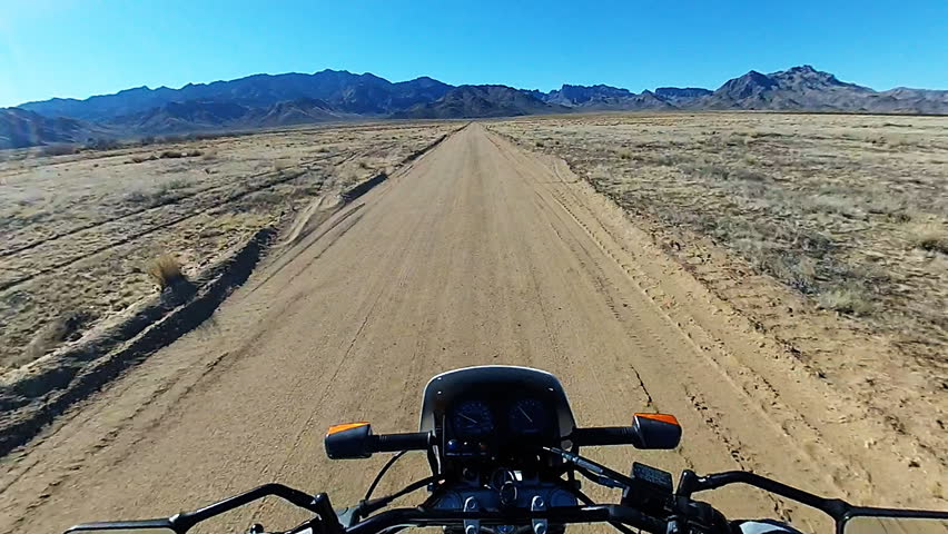 viewpoint motorcycle speeding down dirt road Stock Footage Video (100% ...