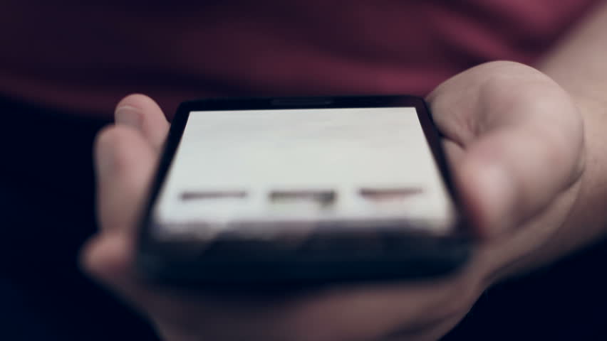 man's hand holding smartphone watching images Stock Footage Video (100% ...