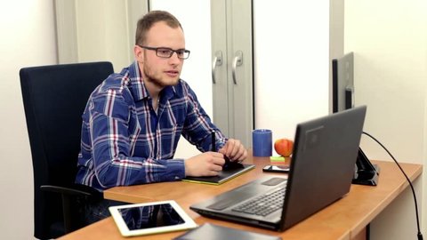 Young Handsome Guy Sitting Behind Desk Stock Footage Video (100% ...