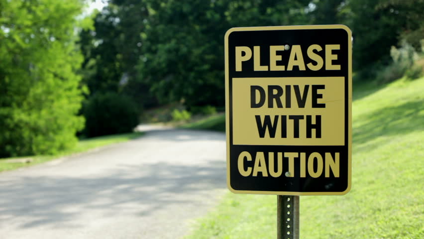 drive caution sign car approaching Stock Footage Video (100% Royalty ...